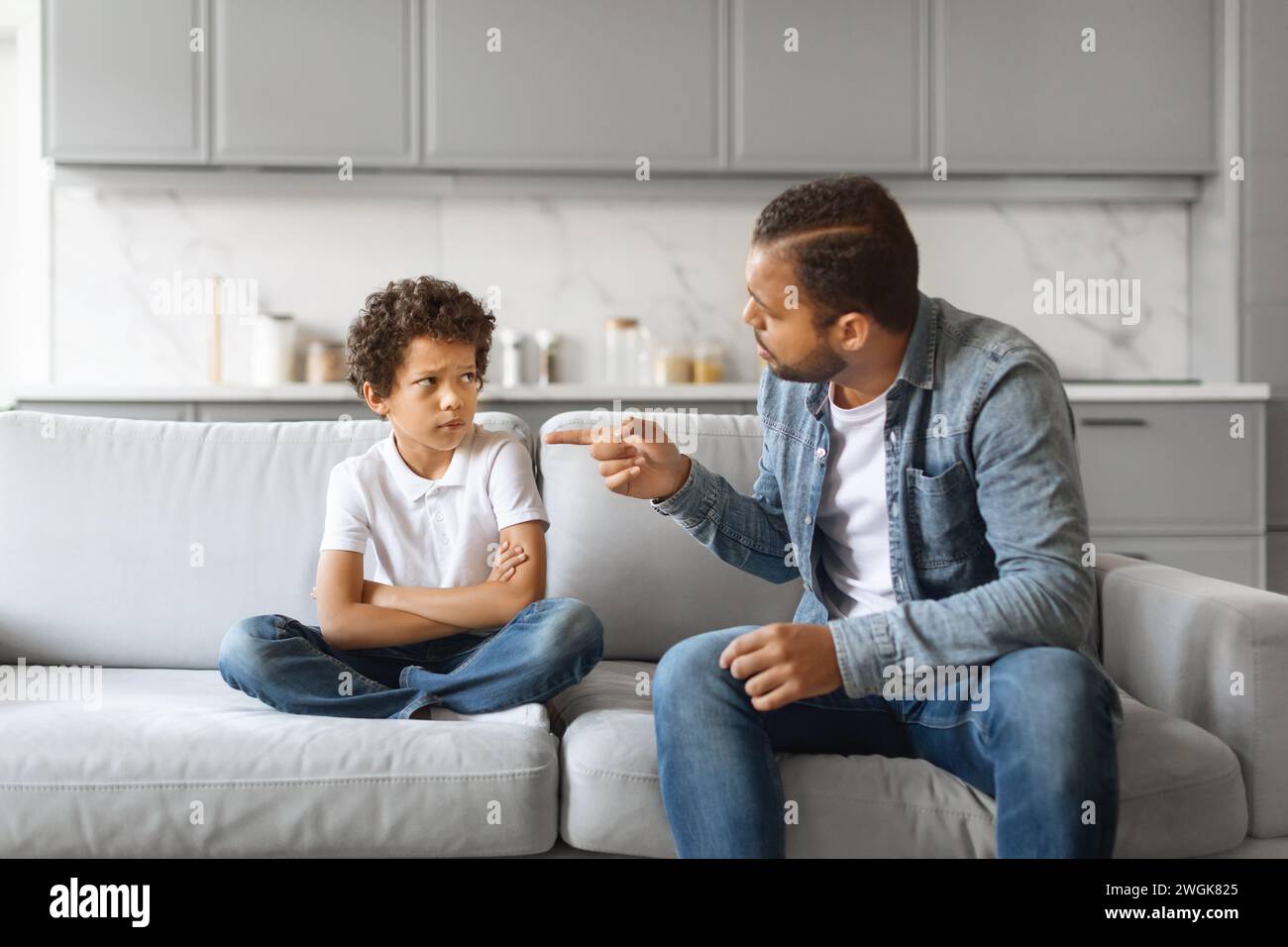 Angry african american father scolding upset little son at home Stock ...