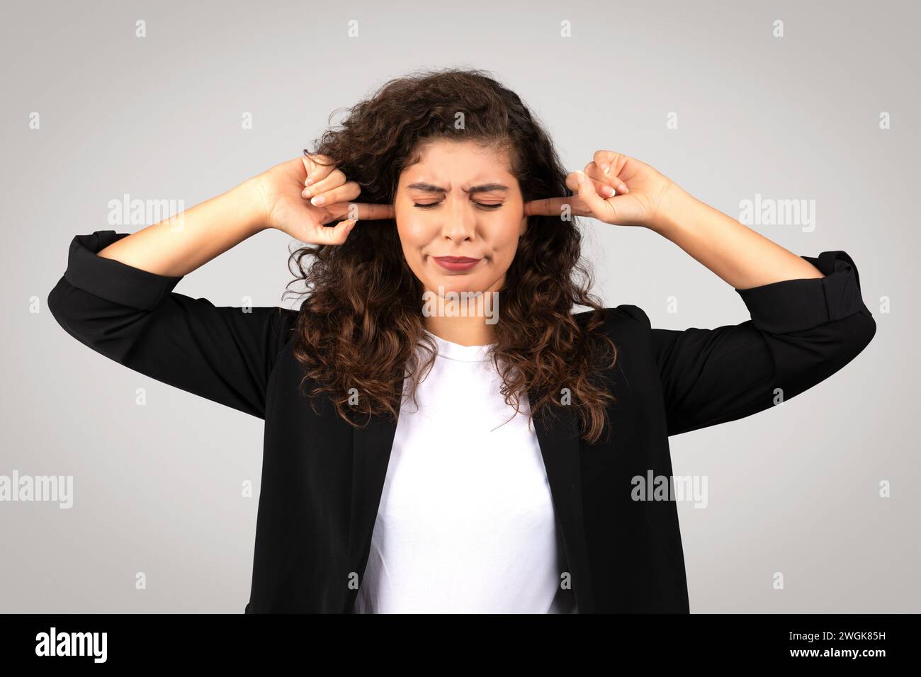 Woman plugging ears hi-res stock photography and images - Alamy