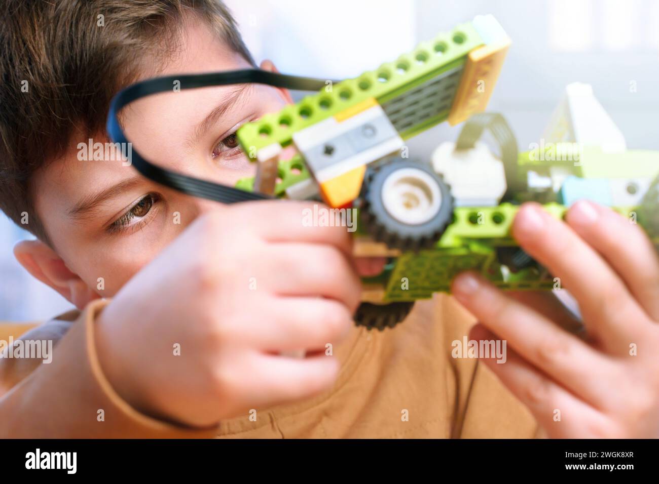 Little boy makes robot toy car. Smart boy assemble constructor kids ...