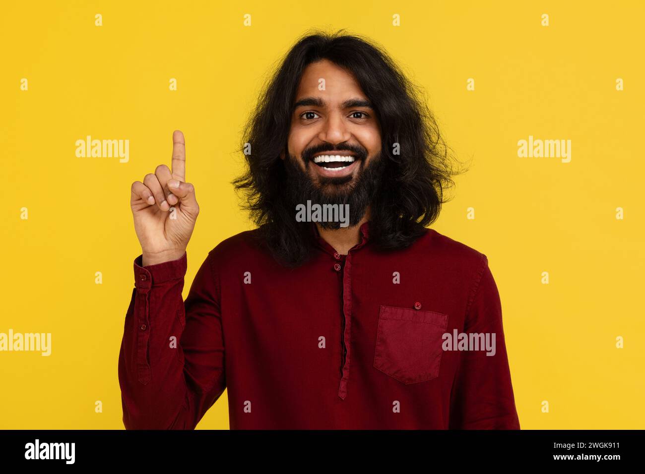 Excited young indian man raising finger up and smiling Stock Photo - Alamy