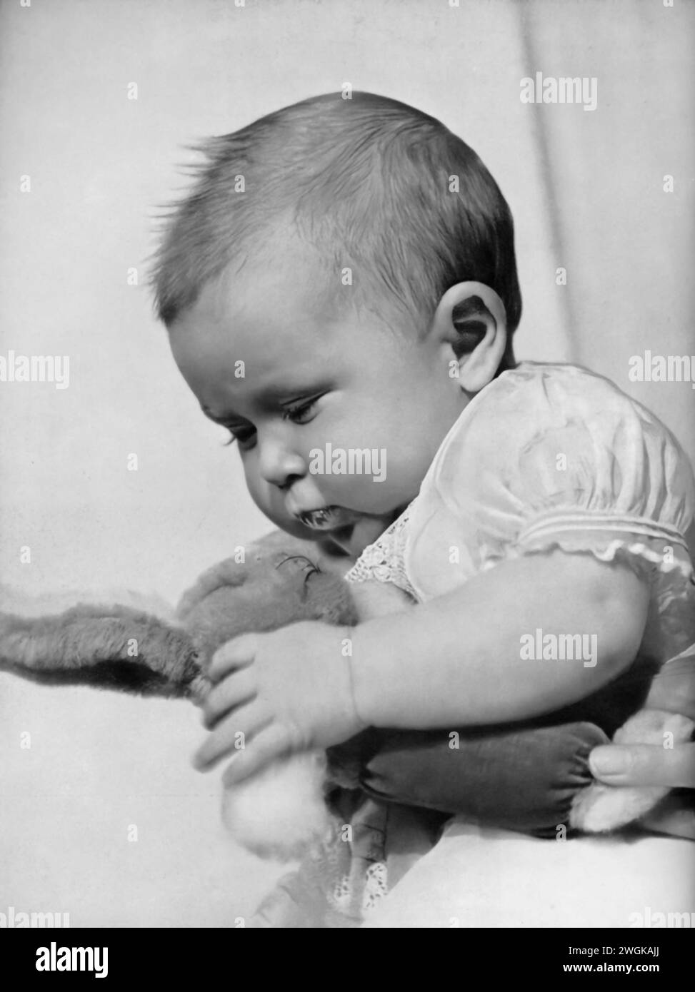 A photograph of the newborn Charles III, captured as he plays with a ...
