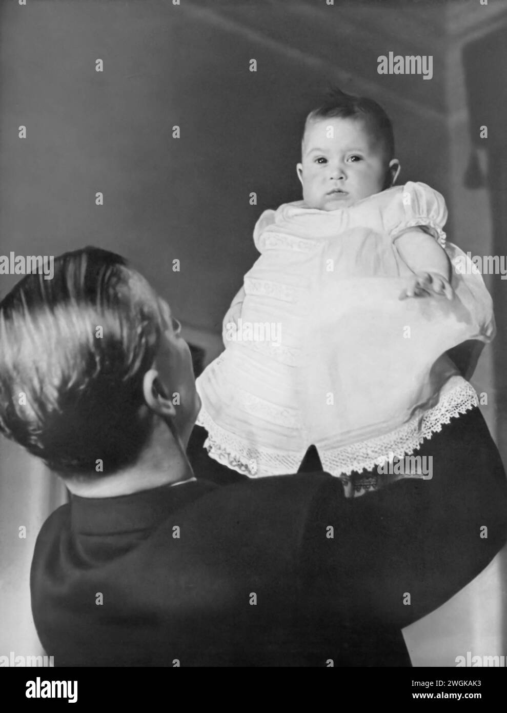 A photograph capturing a moment as Prince Philip holds his newborn son ...