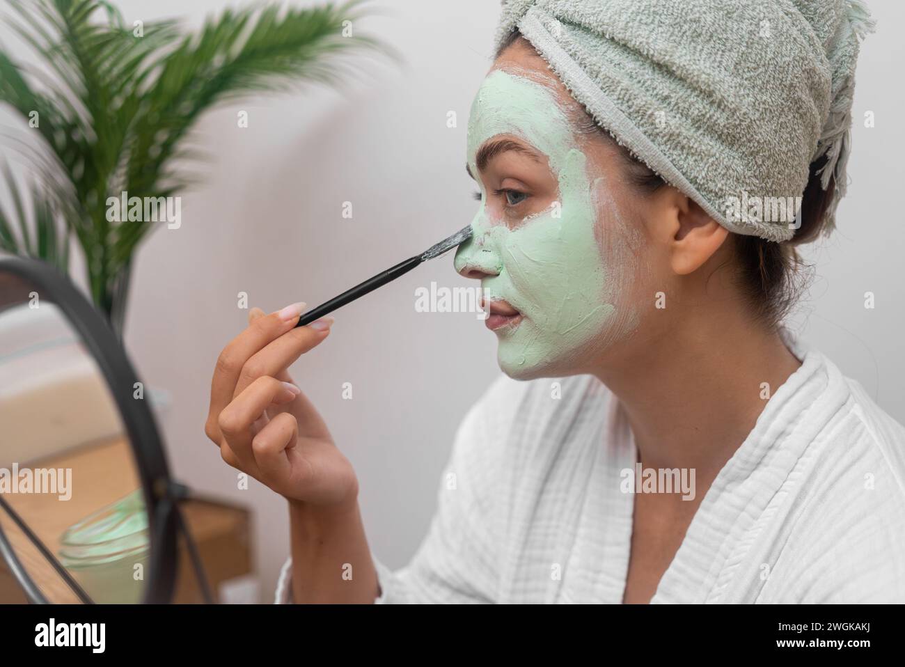 woman face with a moisturizing mask, nurturing her skin's health and ...
