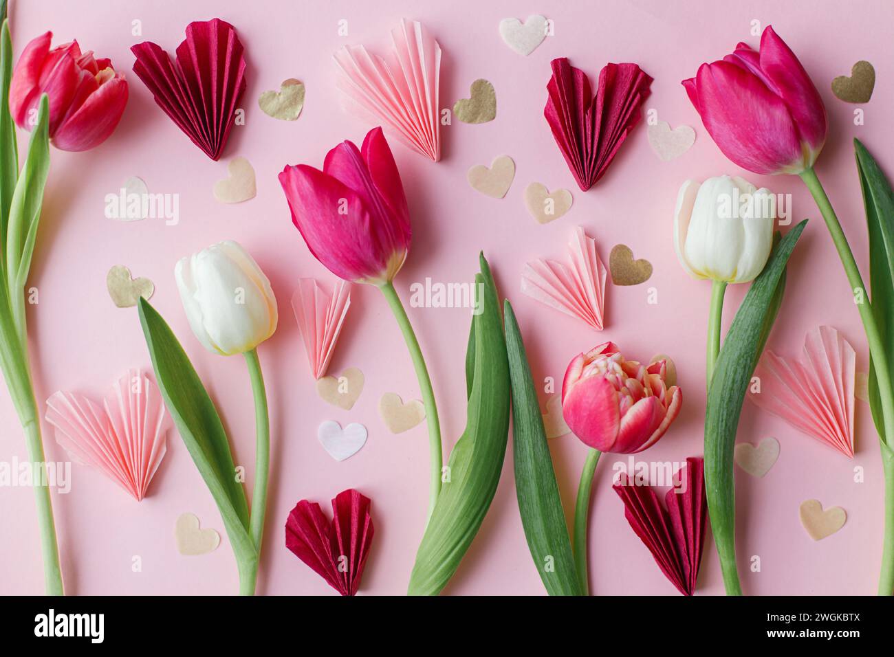 Stylish hearts and tulips on pink background flat lay. Happy Valentines ...