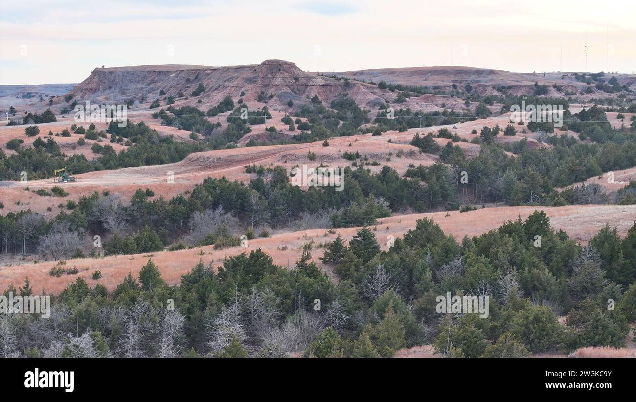 A landscape with rolling hills, trees, and clouds in the sky Stock ...
