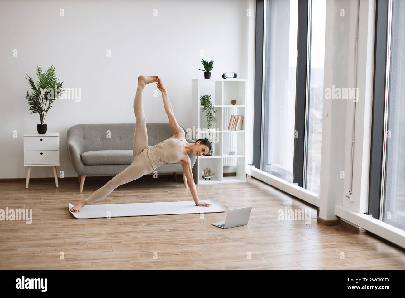 Yogini improving body strength while holding Side Plank Pose with ...