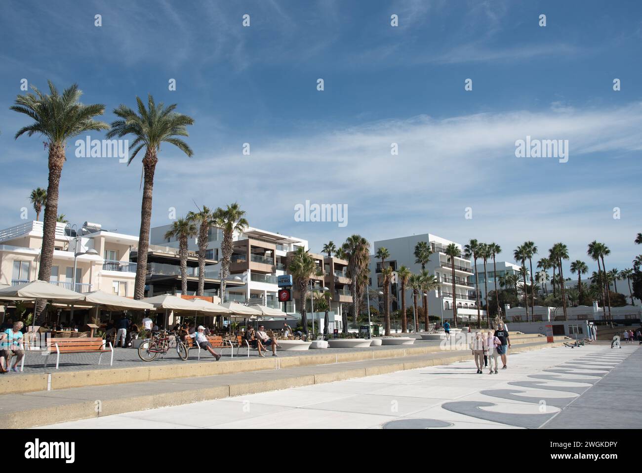 Tourist people walking at footpath in Kato Paphos holiday city resort ...