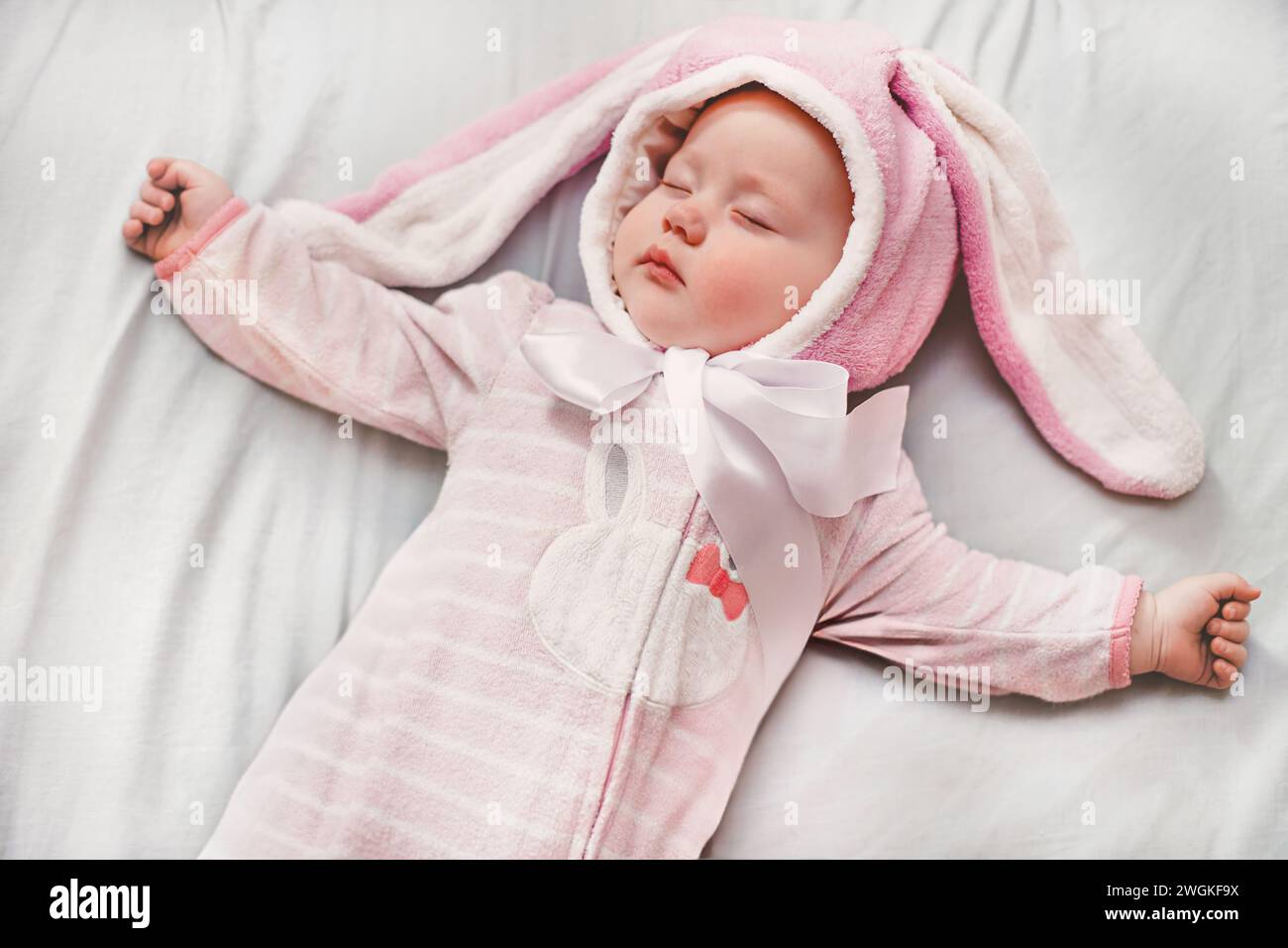 Funny baby sleeping on bed at home. Child daytime bottom up sleeping ...