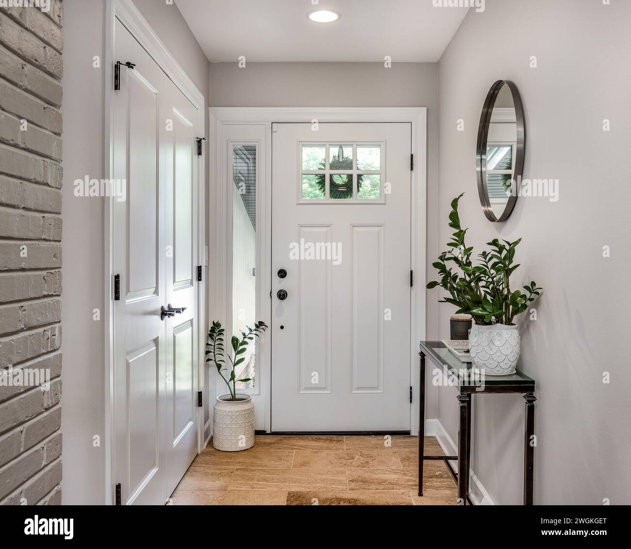 A cozy entryway with brown and brick walls, hardwood flooring ...