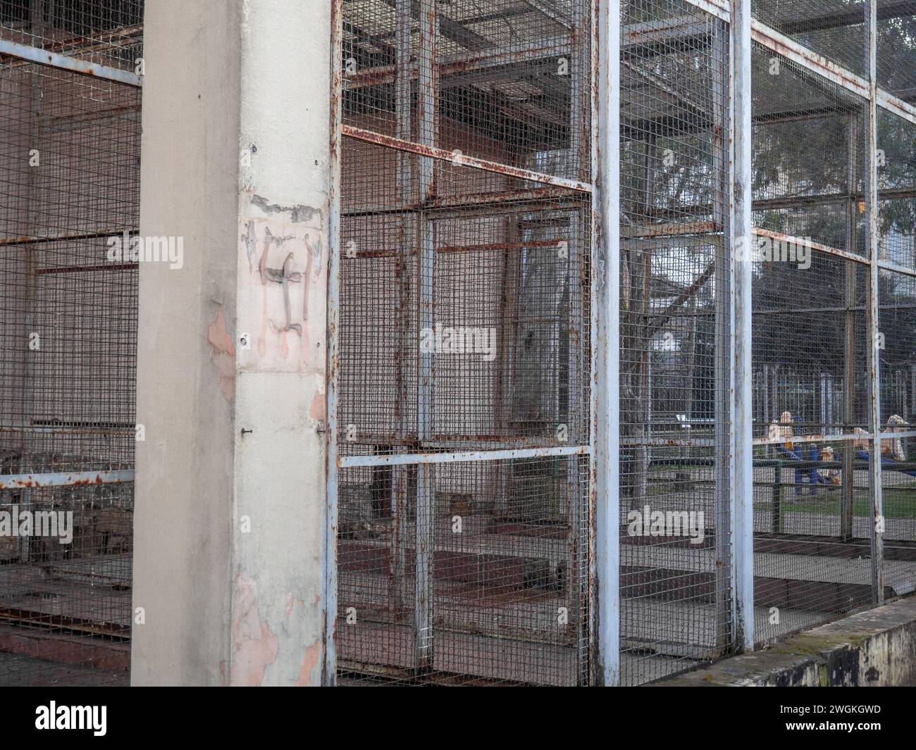 Outdoor fence at the zoo. Empty cages in the zoo. Winter at the zoo ...