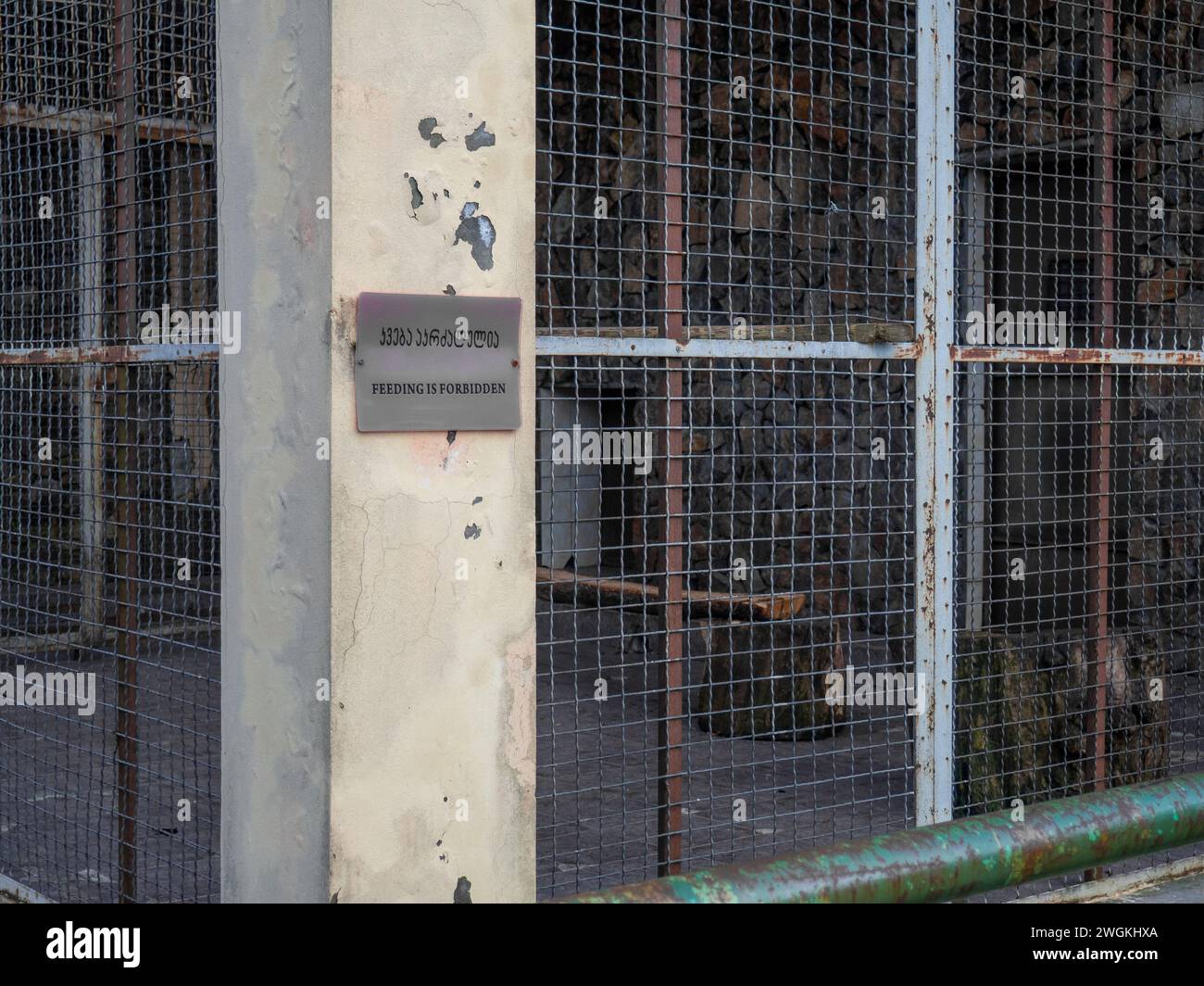 Outdoor fence at the zoo. Empty cages in the zoo. Winter at the zoo ...
