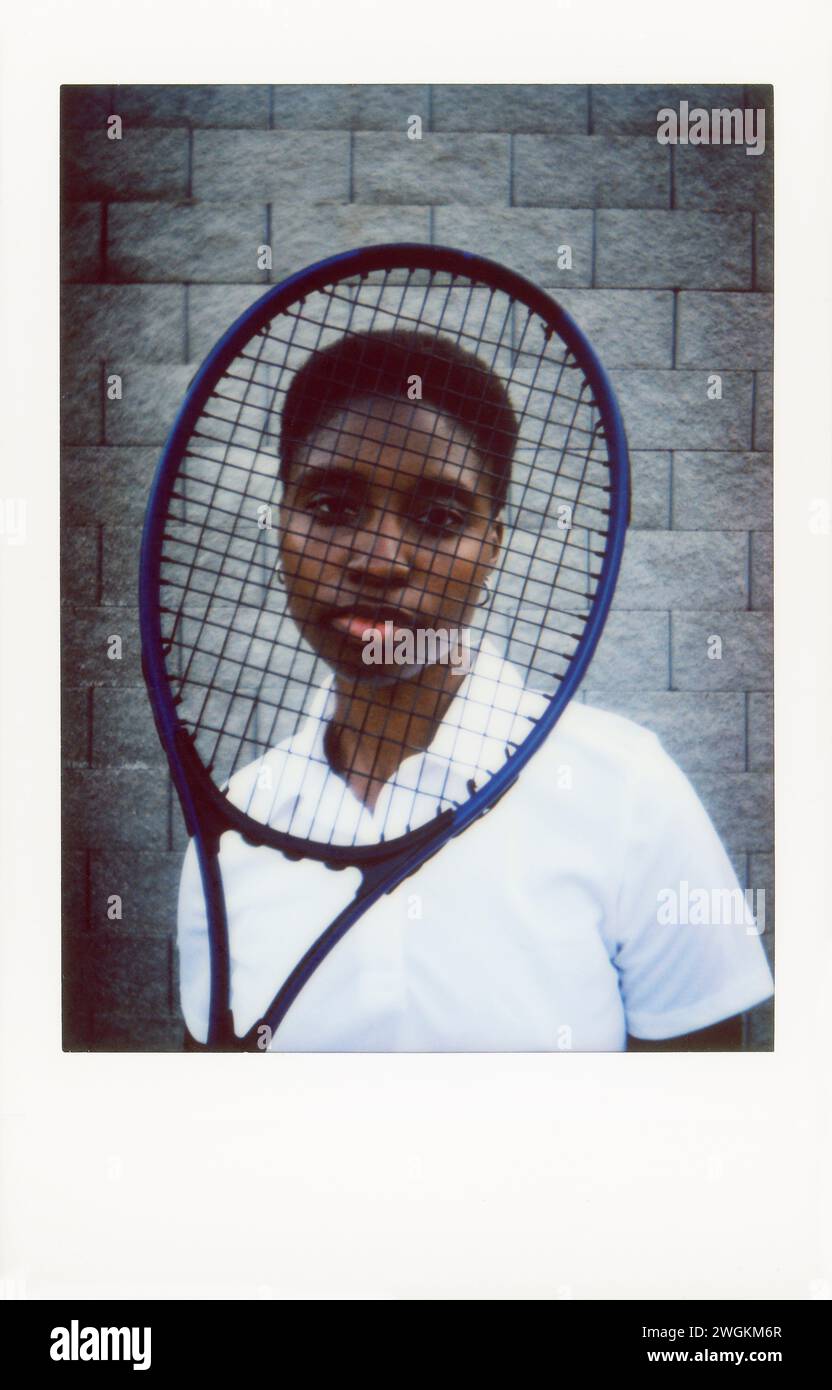 Portrait of a young african american woman with tennis racket on her ...