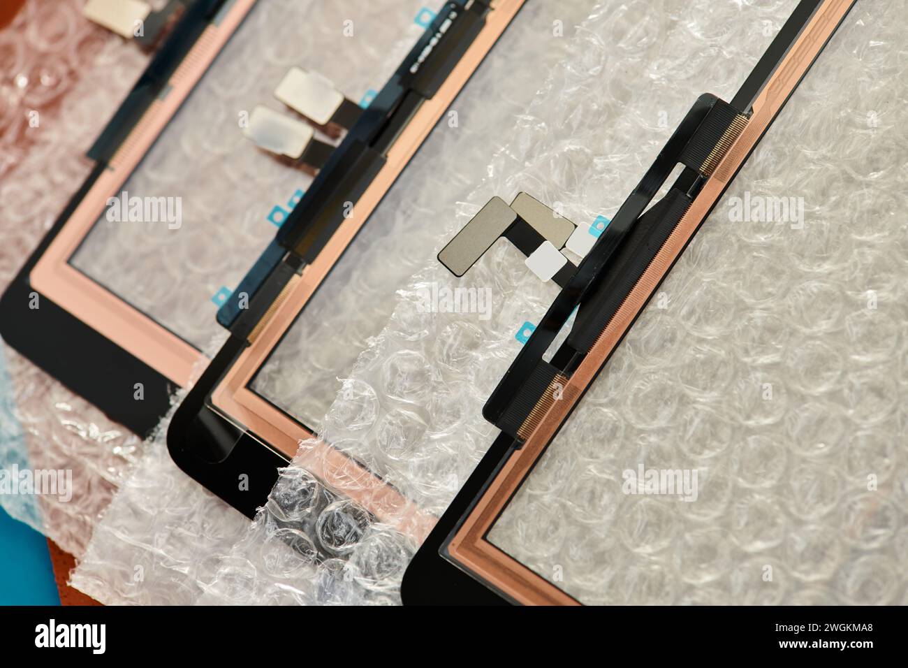 top view of new screens for mobile phones in professional repair shop ...