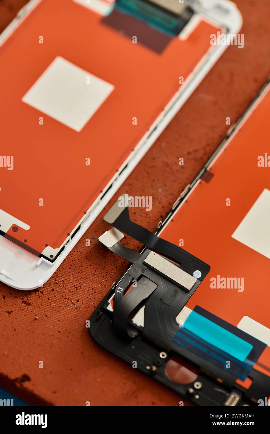 top view of disassembled smartphones on table in workshop electronic ...