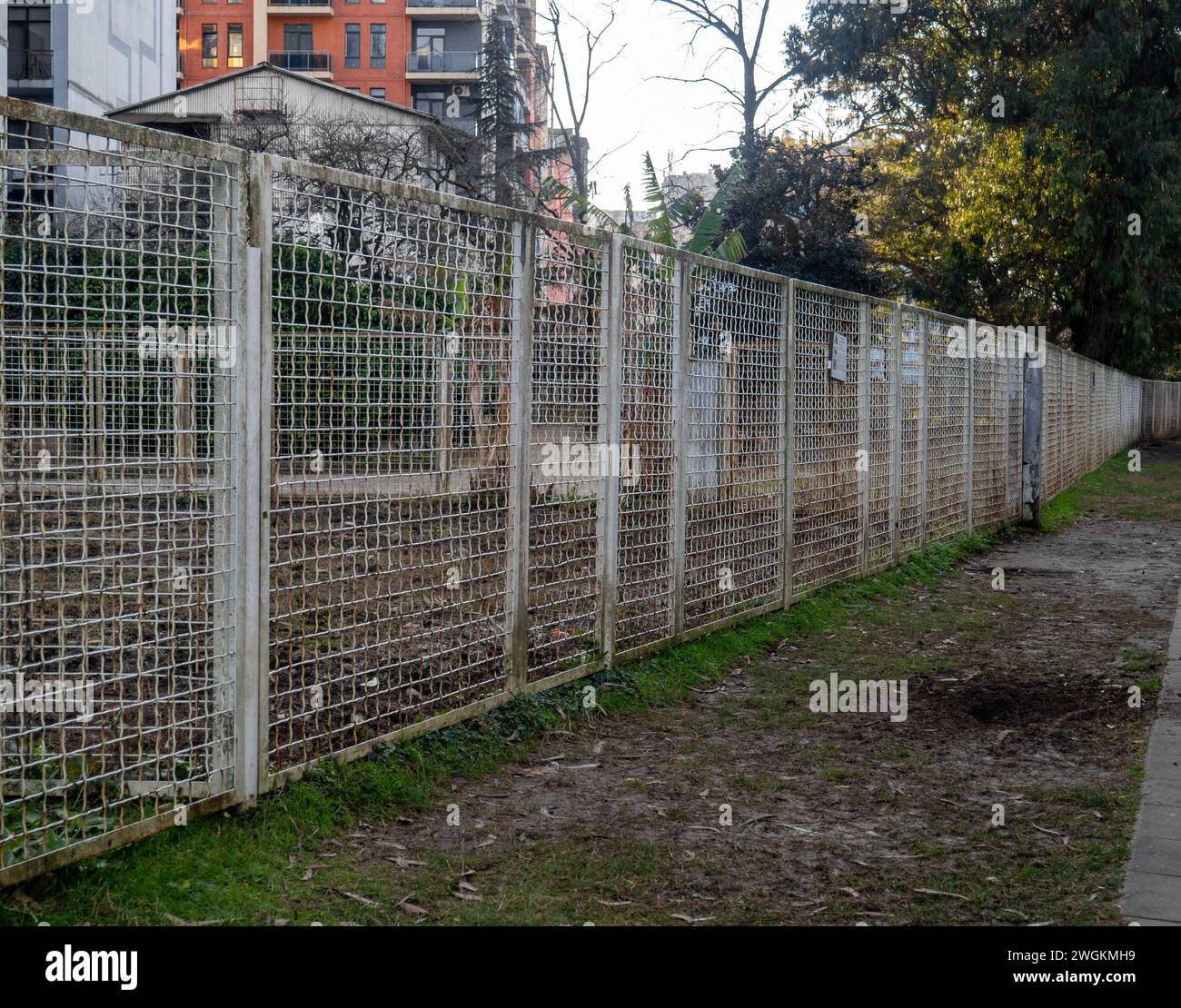 Empty animal enclosure. Outdoor fence at the zoo. Empty cells. Winter ...