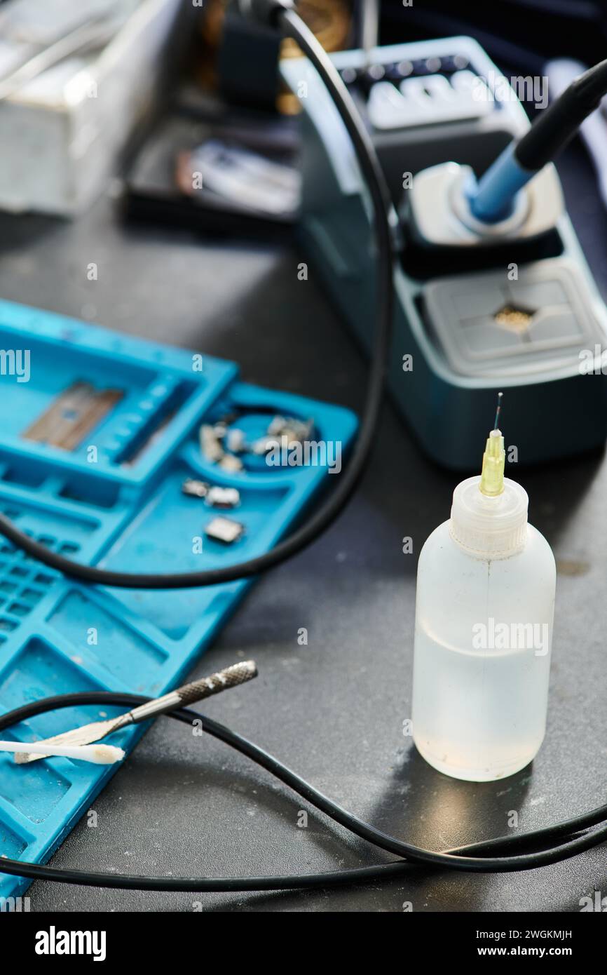 plastic bottle and professional testing equipment on table in repair ...