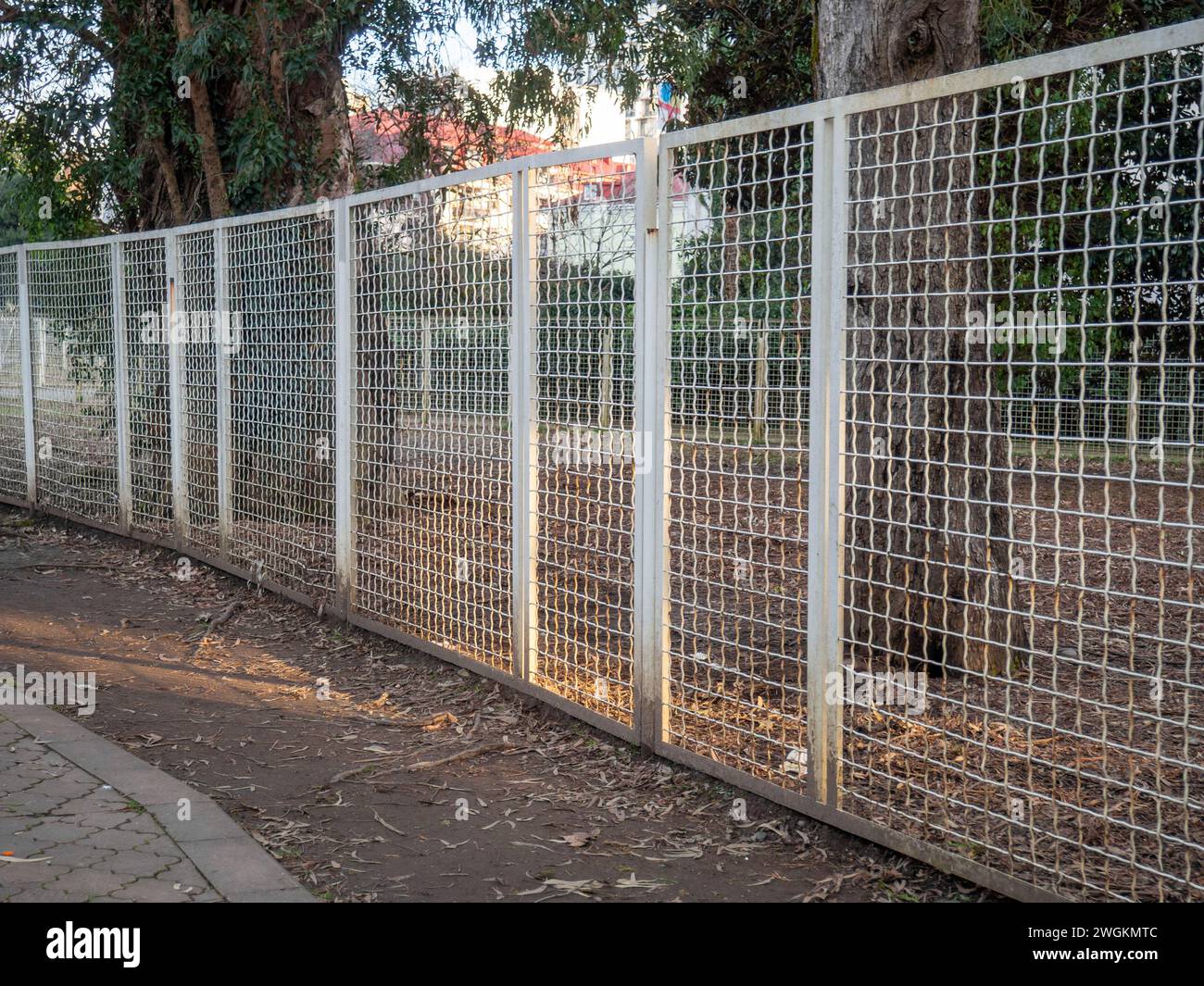 Empty animal enclosure. Outdoor fence at the zoo. Empty cells. Winter ...