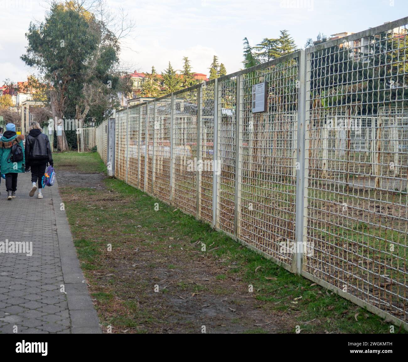 Empty animal enclosure. Outdoor fence at the zoo. Empty cells. Winter ...