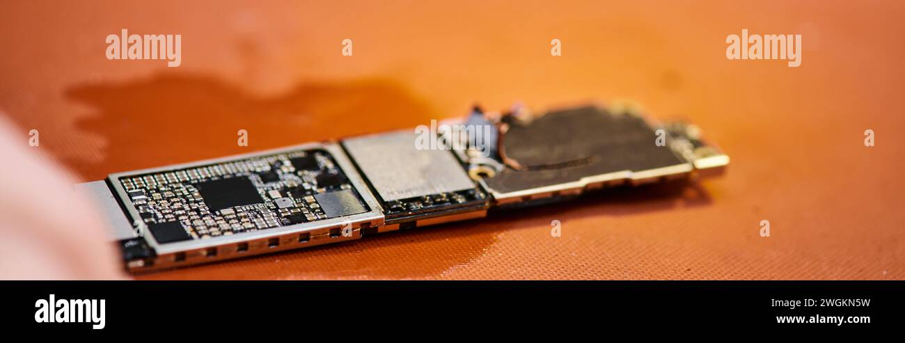 electronic microscheme with chipset on table in workshop, phone repair ...