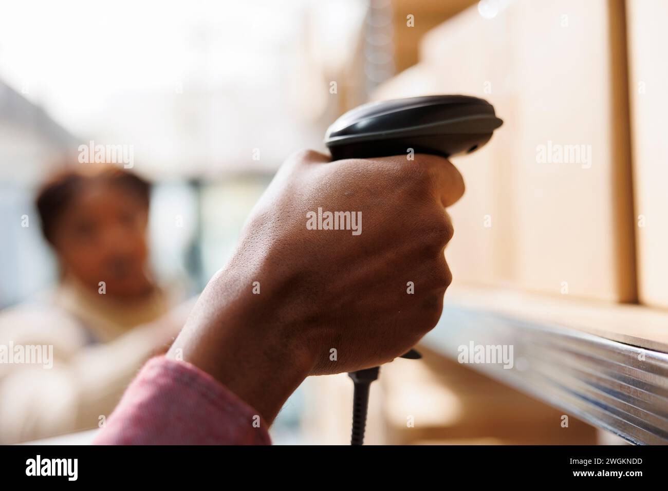 African american warehouse worker hand holding barcode scanner and ...