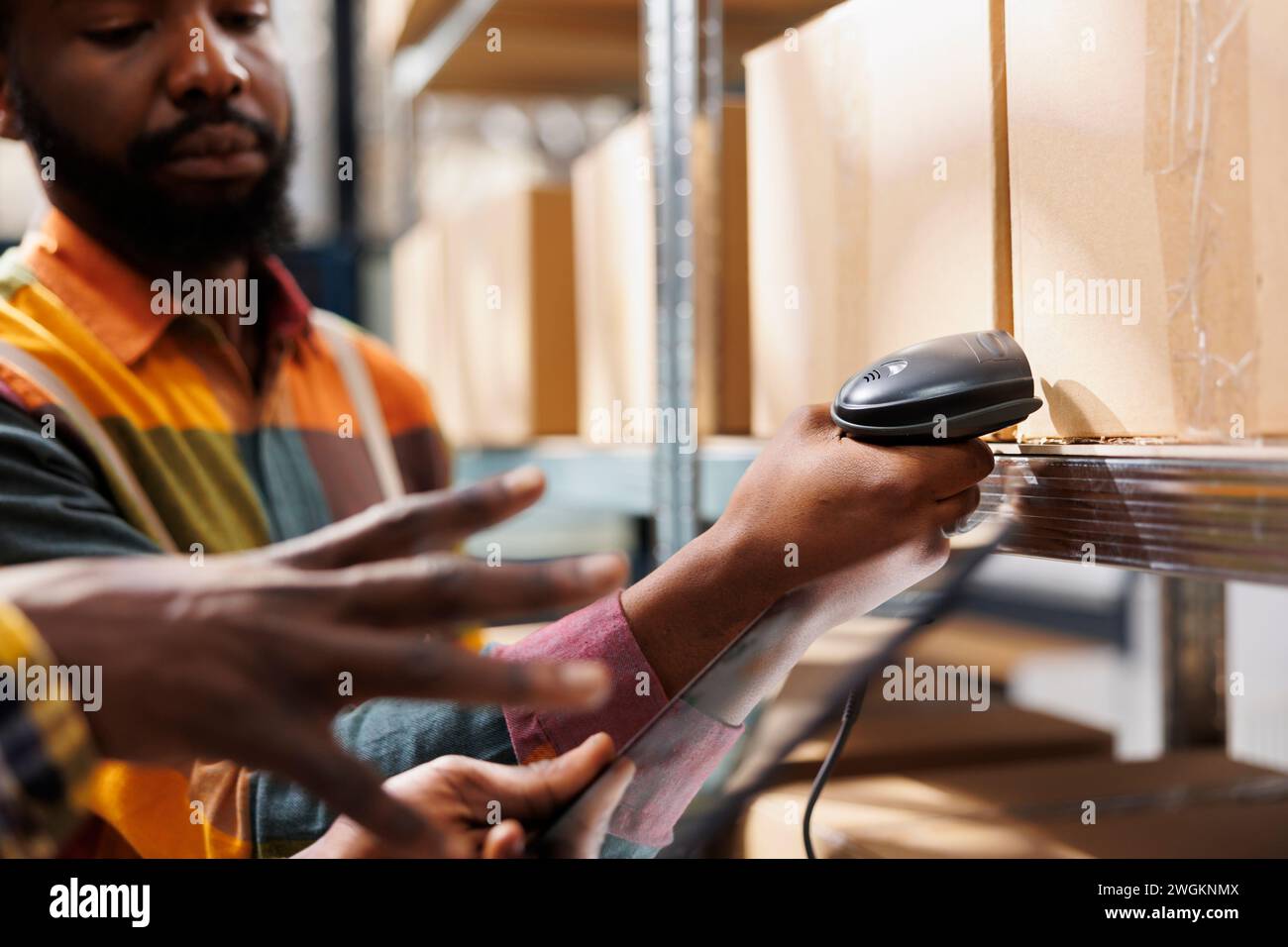 Delivery service employees checking cardboard box qr code in warehouse ...