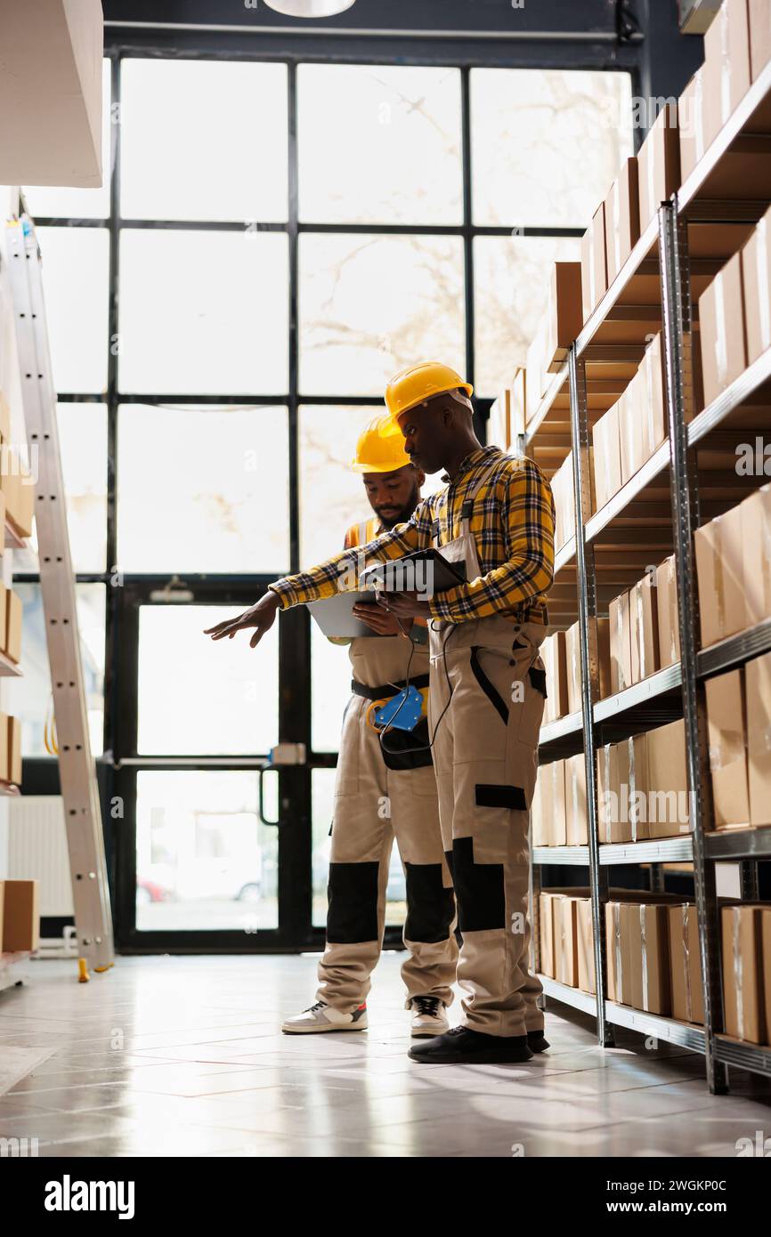 Warehouse managers checking parcels stock using orders checklist ...