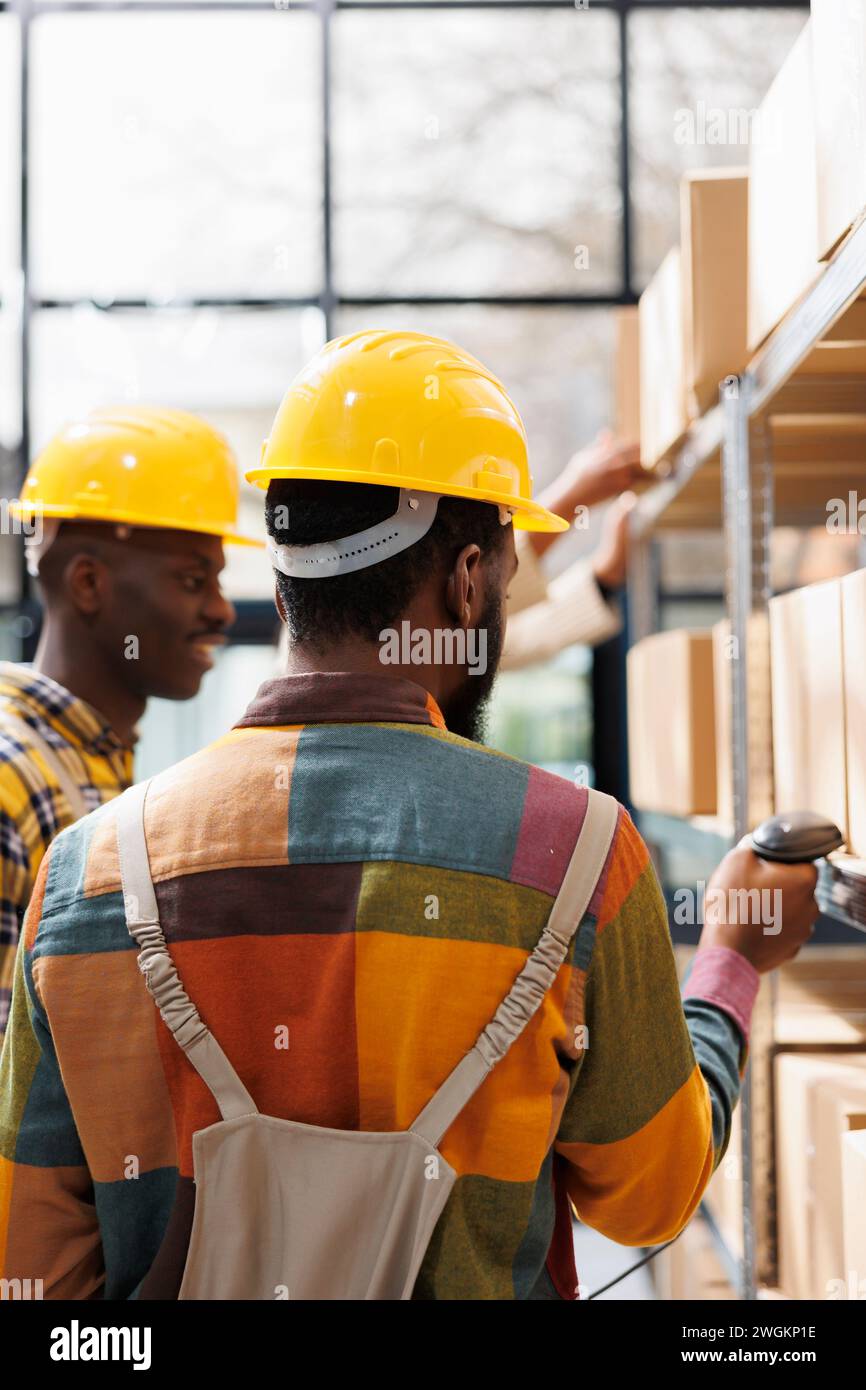 Merchandise managers analyzing stock inventory using barcode scanner in ...