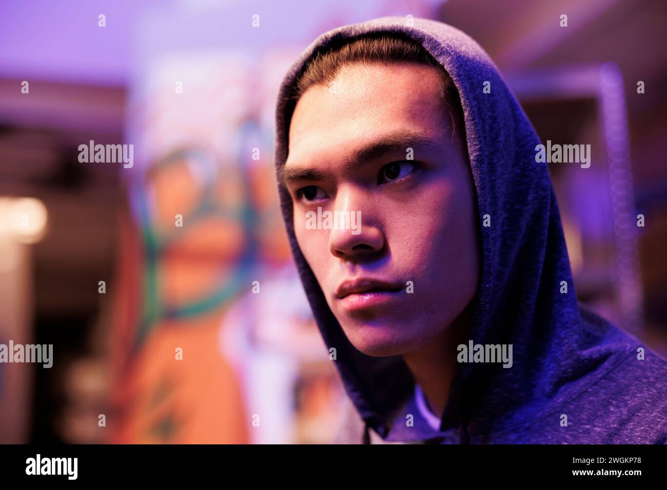 Focused asian hacker in hood hacking server and cracking complex ... Focused asian hacker in hood hacking server and cracking complex ...