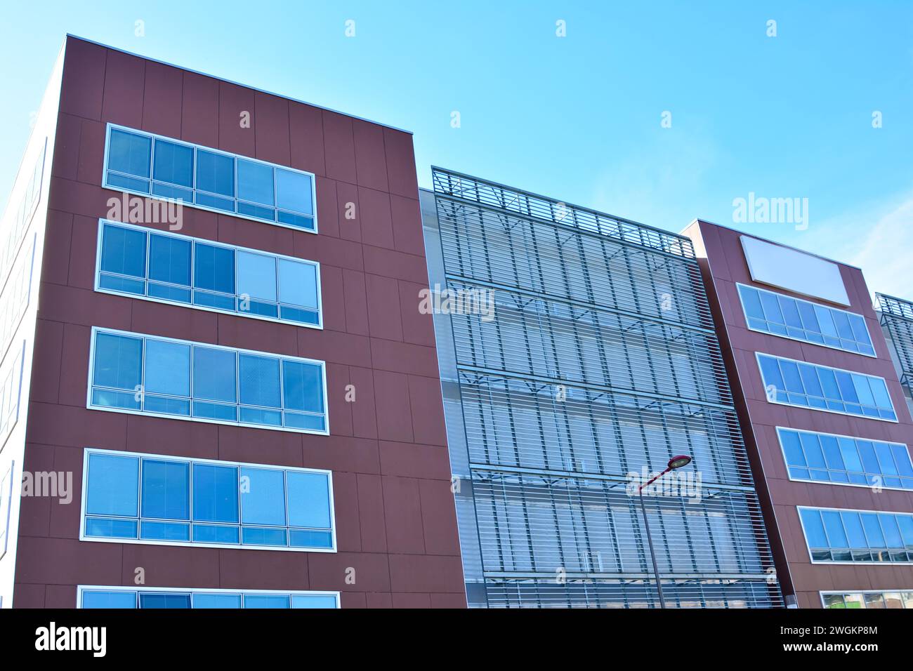 Modern red building with glass windows Sky background Stock Photo - Alamy