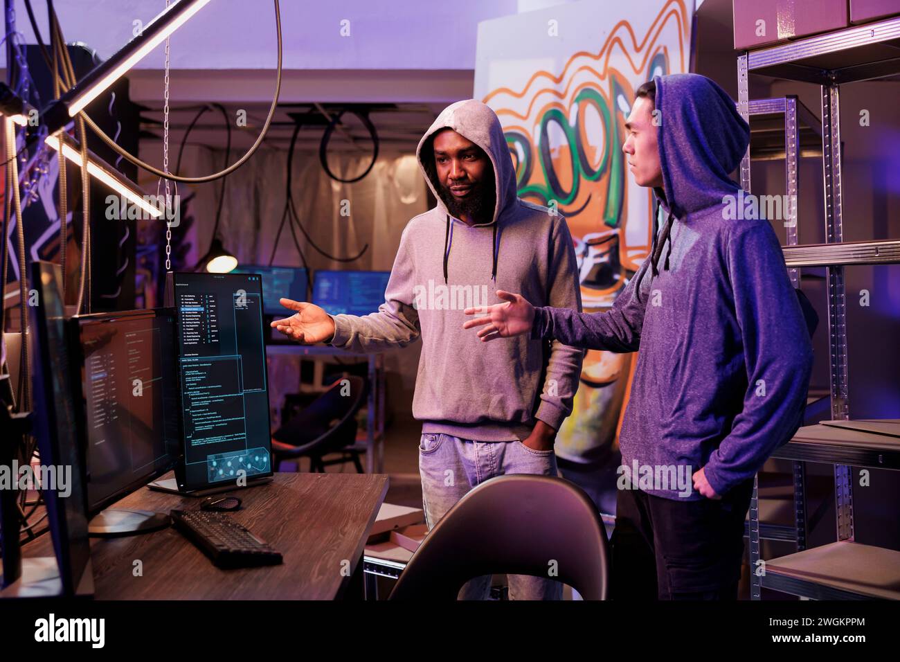 Hackers discussing hacking plan and cybercrime technique. Criminals in hood standing near ...