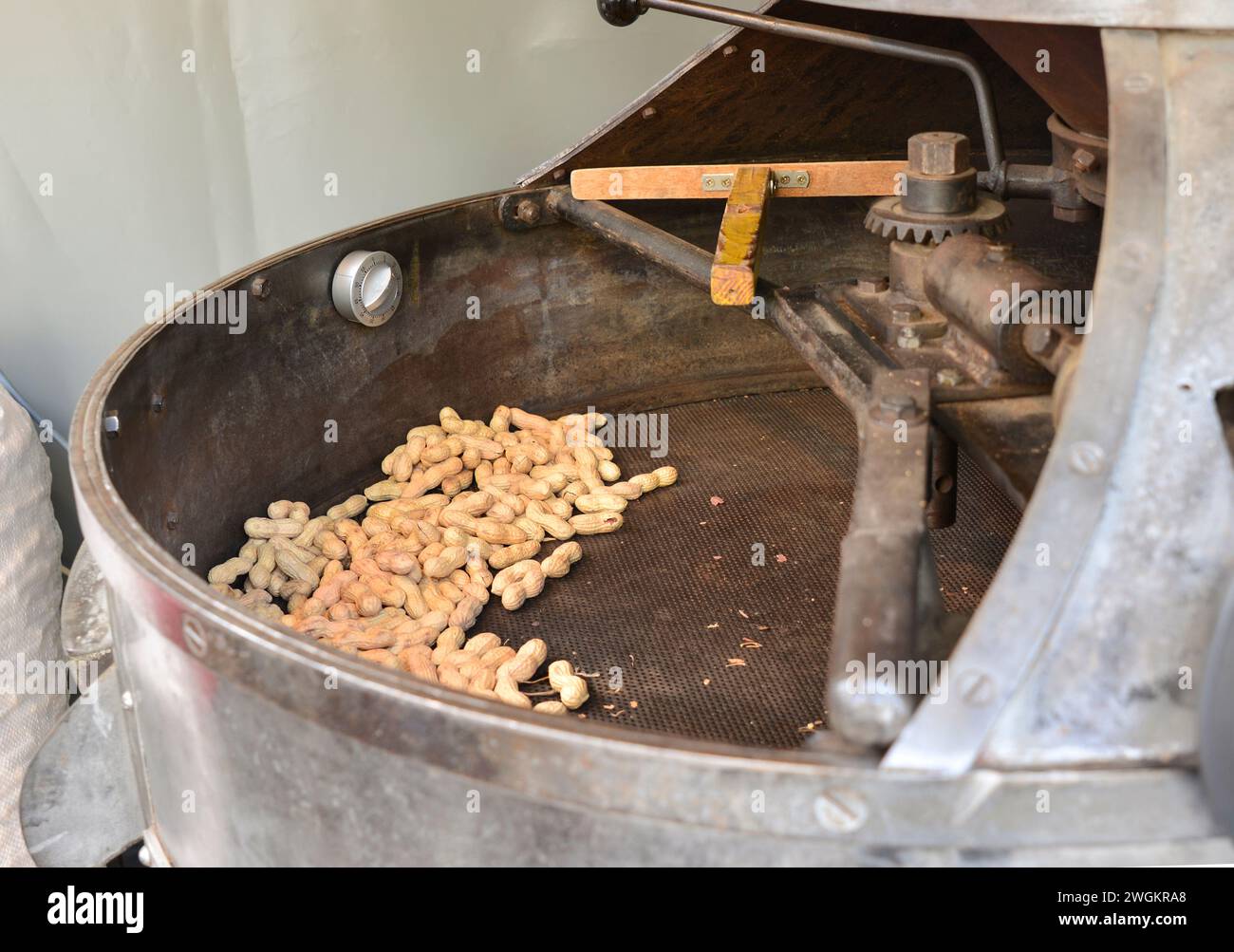 Roasted peanuts in an old machine-oven Stock Photo - Alamy