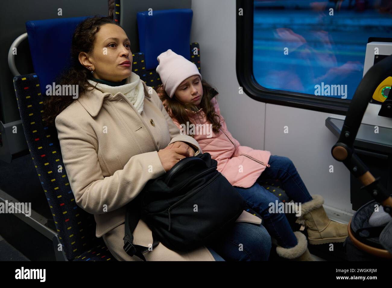 Portrait of diverse people travelling by train. Young woman ...