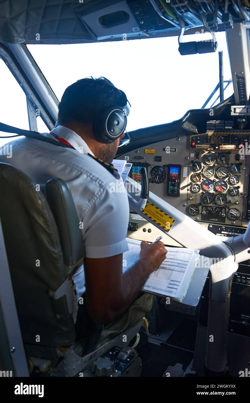 Pilots flying a sea plane from the Trans Maldivian Airways fleet Stock ...