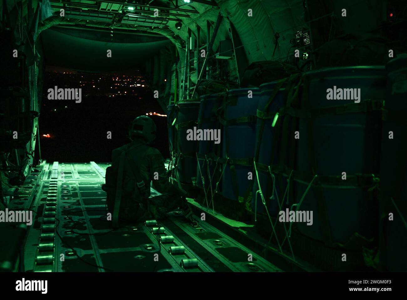A loadmaster assigned to the 41st Airlift Squadron prepares for a mass ...