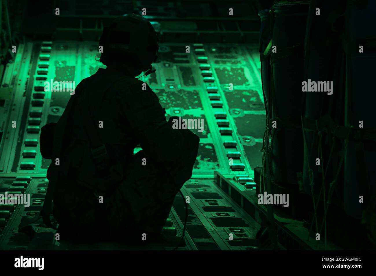 A loadmaster assigned to the 41st Airlift Squadron prepares for a mass ...