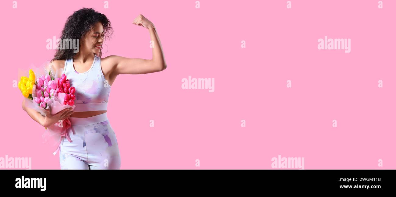 Young sporty African-American woman with bouquets of flowers showing ...