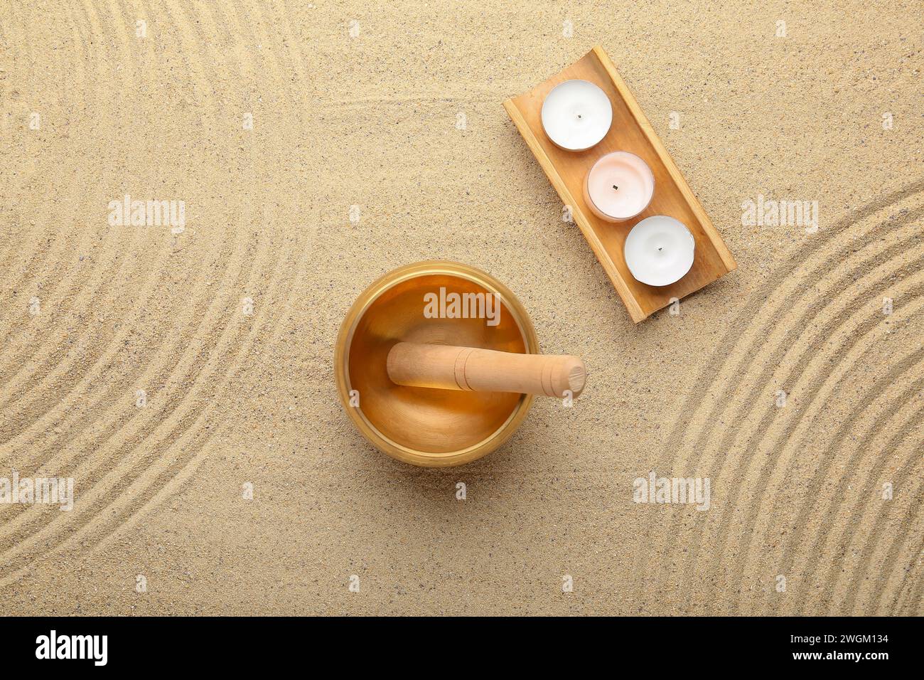 Wooden tray with candles, mortar and pestle on sand. Zen concept Stock ...