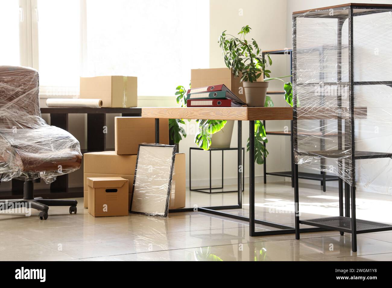 Interior of office with chair wrapped in stretch film and cardboard ...