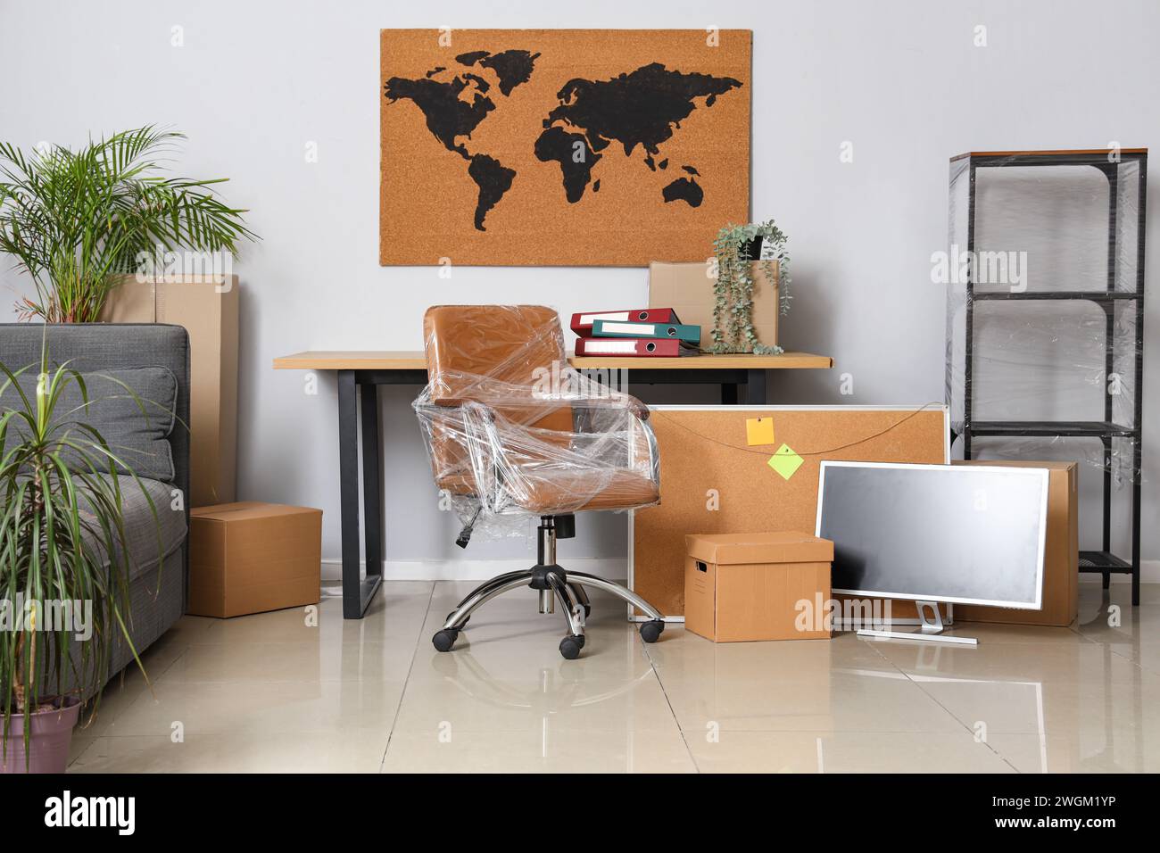 Interior of office with chair wrapped in stretch film and cardboard ...