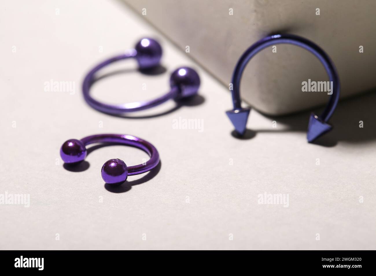 Set of circular barbells for piercing on light background Stock Photo ...