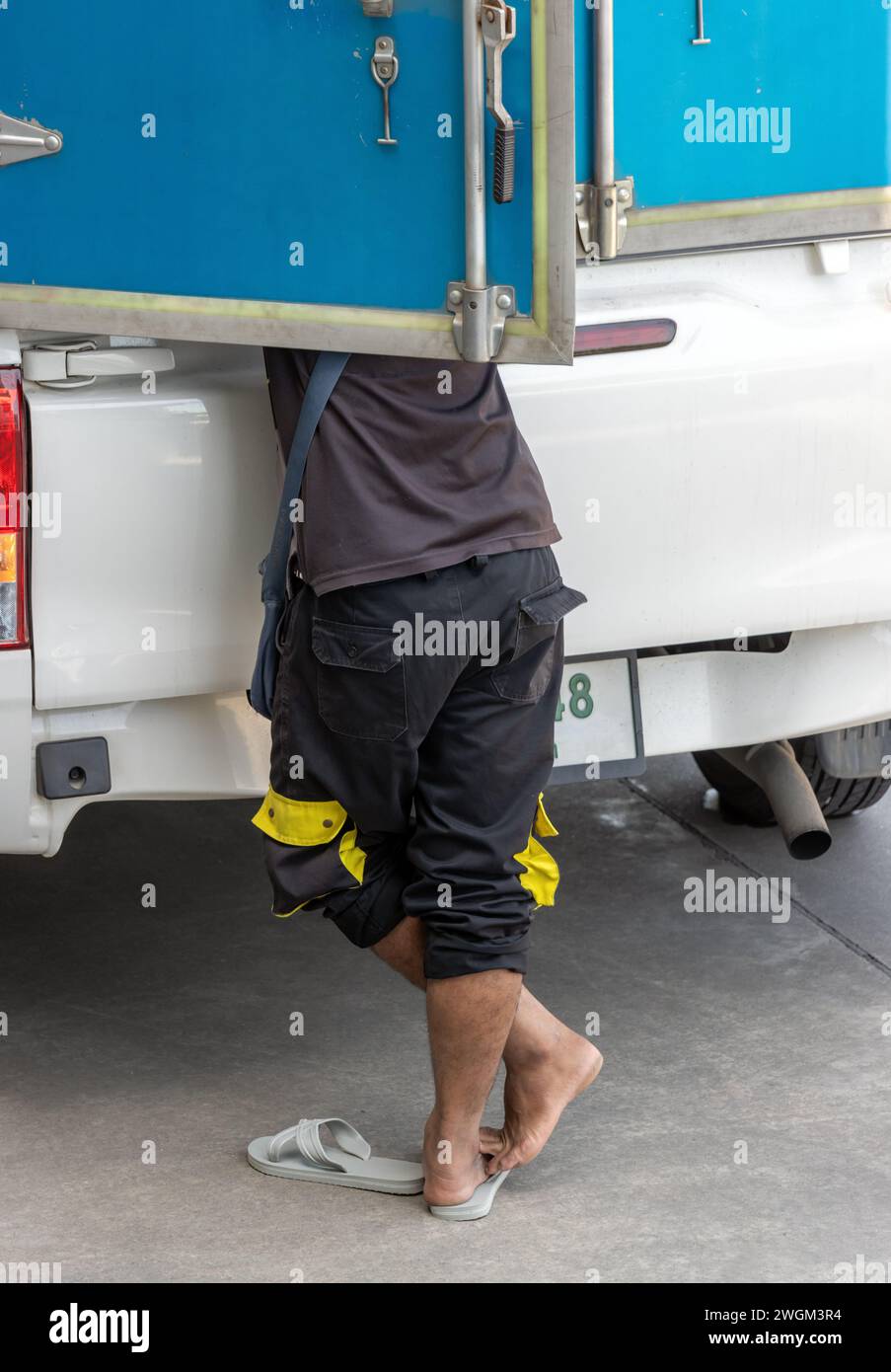 The courier of the delivery service checks the parcels in the car Stock ...