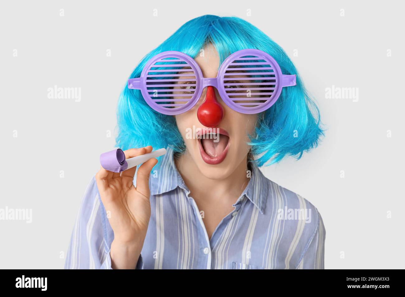 Beautiful young shocked woman in funny disguise with party whistle on ...