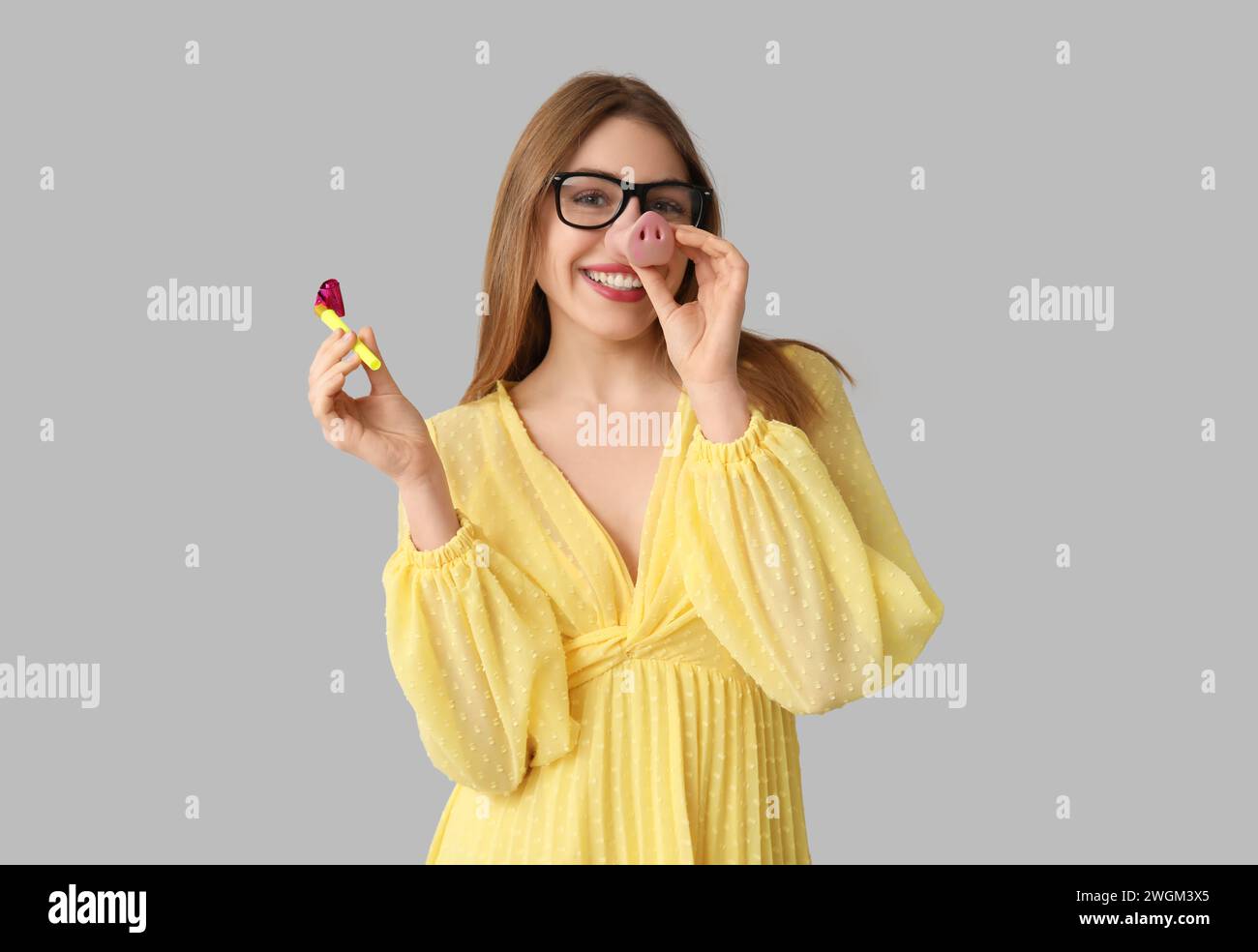 Beautiful young happy woman in funny disguise with party whistle on ...