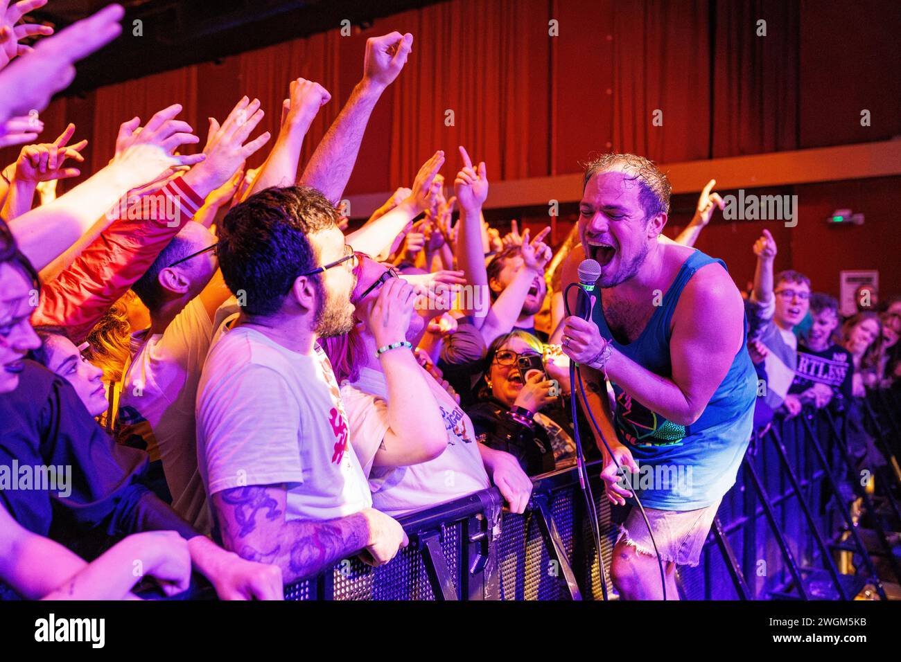 Jeff Rosenstock performing at the crowd barrier in front of cheering ...