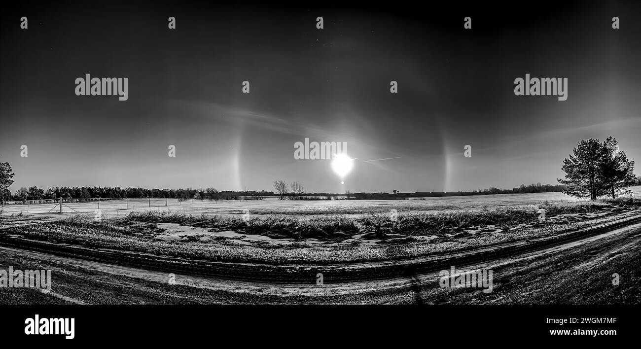 Atmospheric optical phenomenon sun dogs in the morning across a snow ...