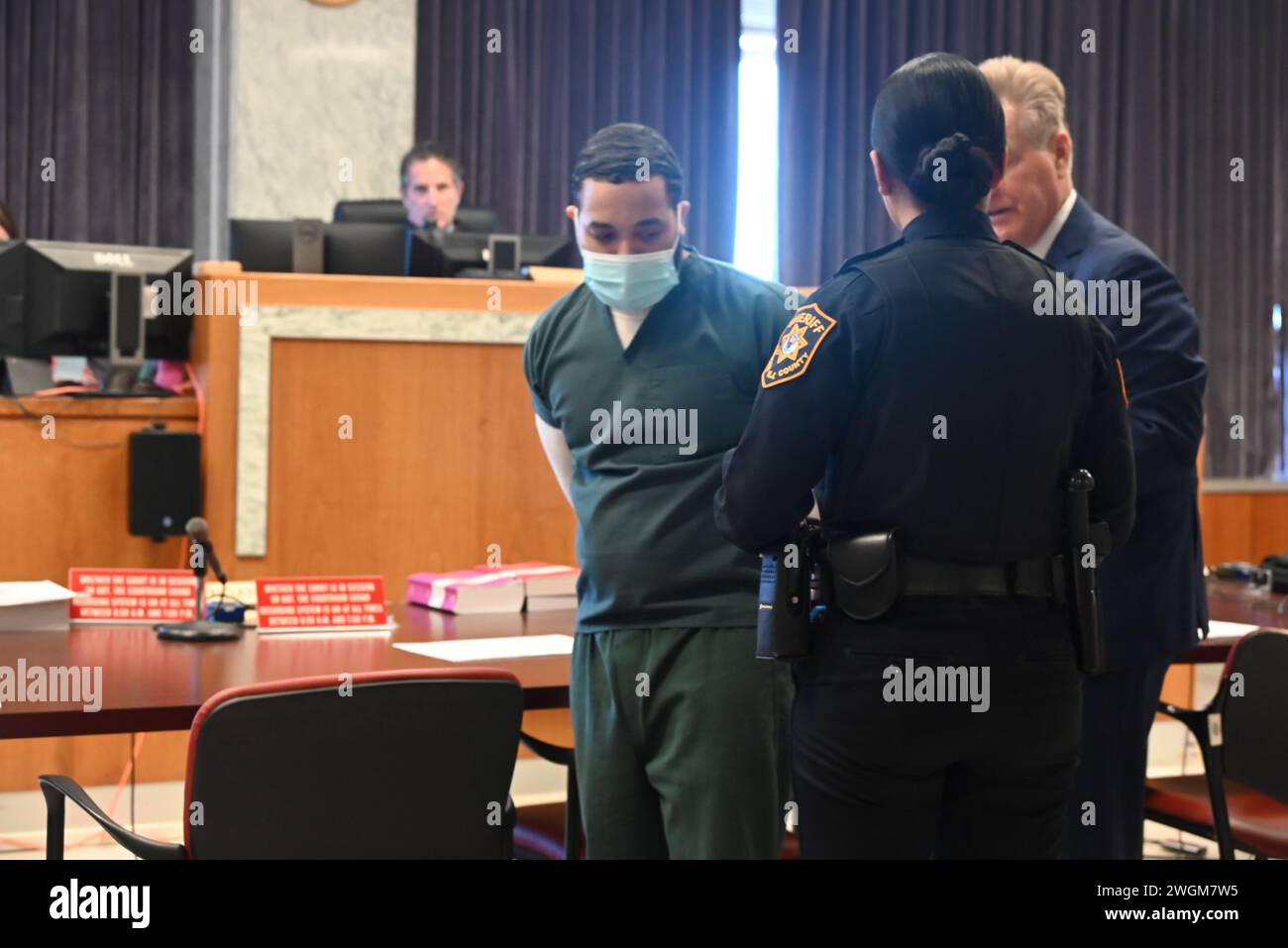 Cesar Santana in court wearing a jailhouse uniform and handcuffs. Cesar ...