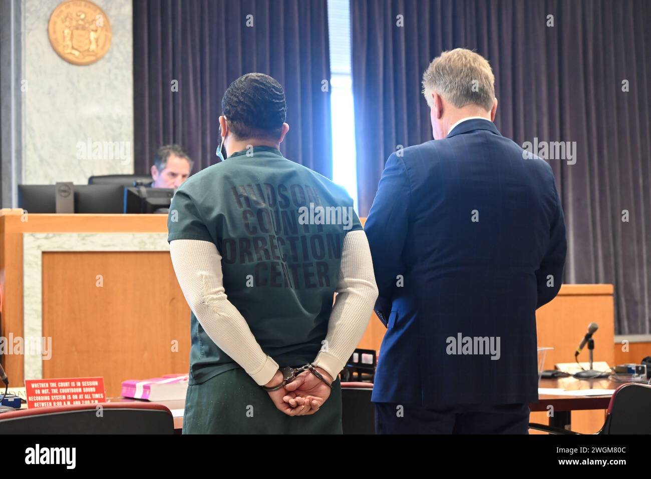 Cesar Santana in court wearing a jailhouse uniform and handcuffs. Cesar ...