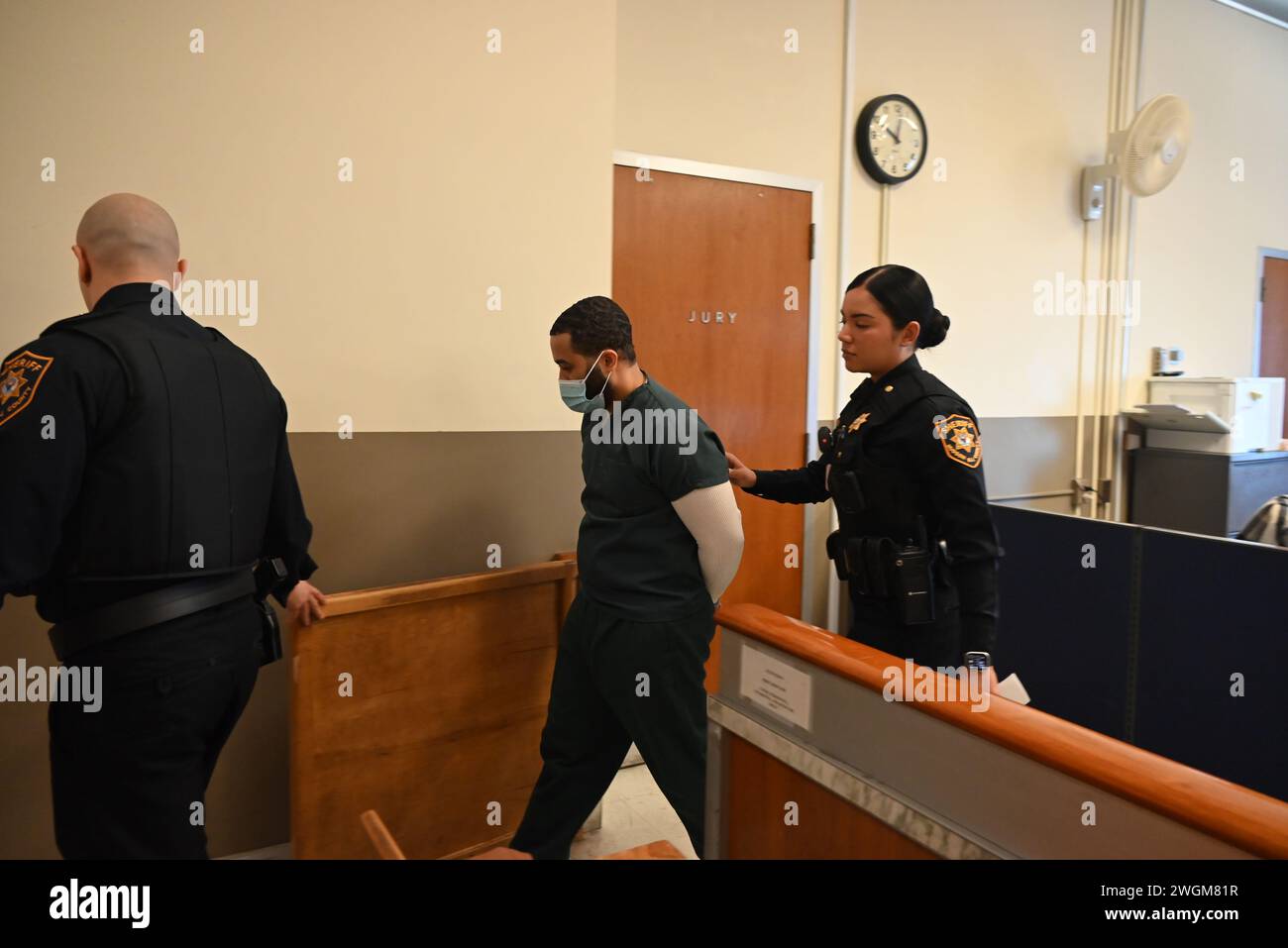 Cesar Santana in court wearing a jailhouse uniform and handcuffs. Cesar ...