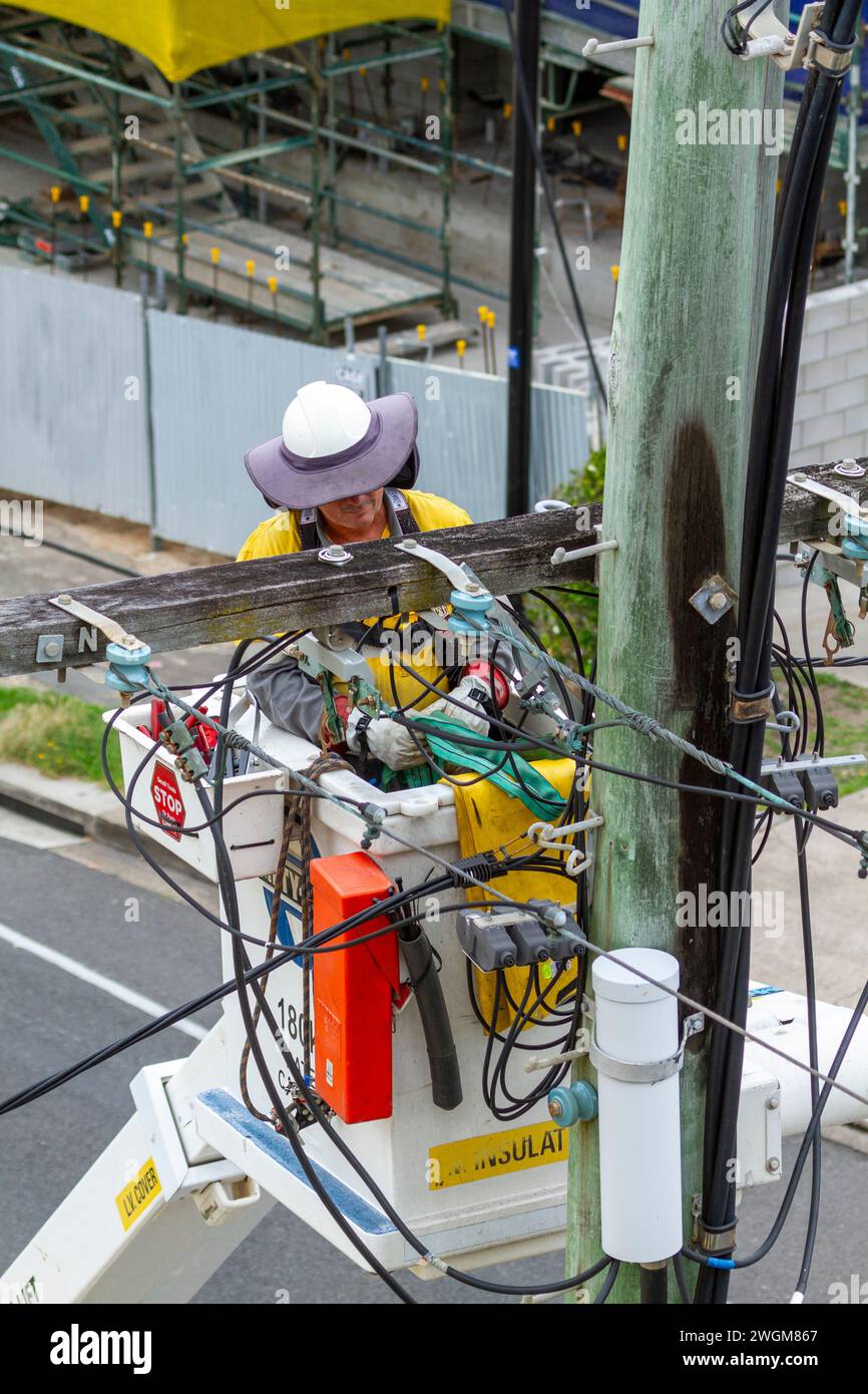Electricity Lineman working on power line infrastructure from a lift ...