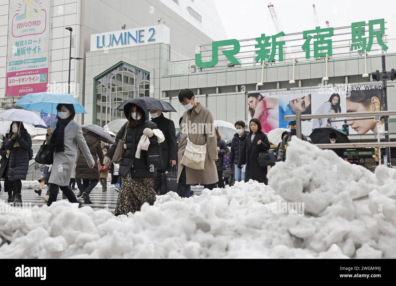 People make their way on a street in Toko Tuesday, Feb. 6, 2024, a day ...